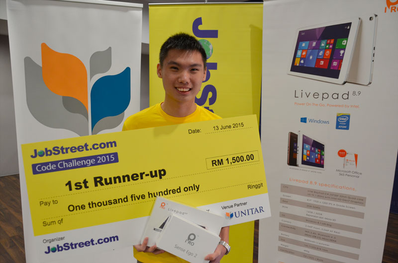 Lim with his mock cheque and prizes from the competition